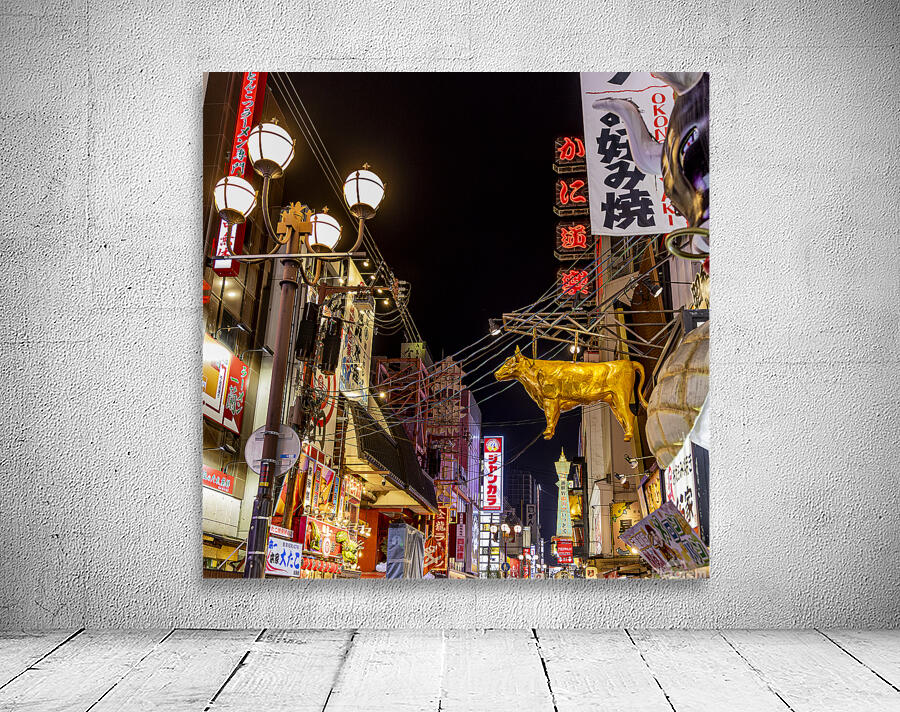 Golden cow sculpture hangs over a busy street osaka by Gualtiero Boffi ...